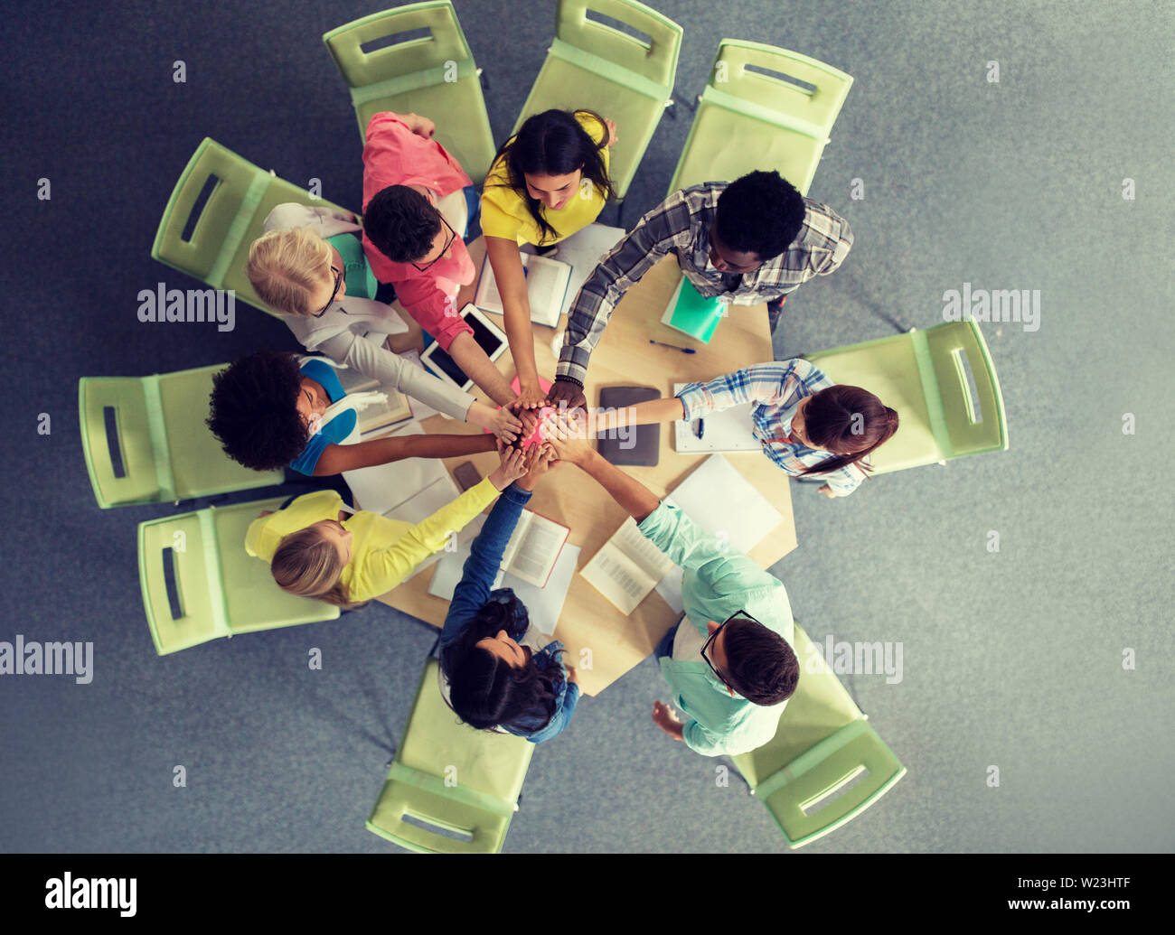 group of international students making high five Stock Photo - Alamy