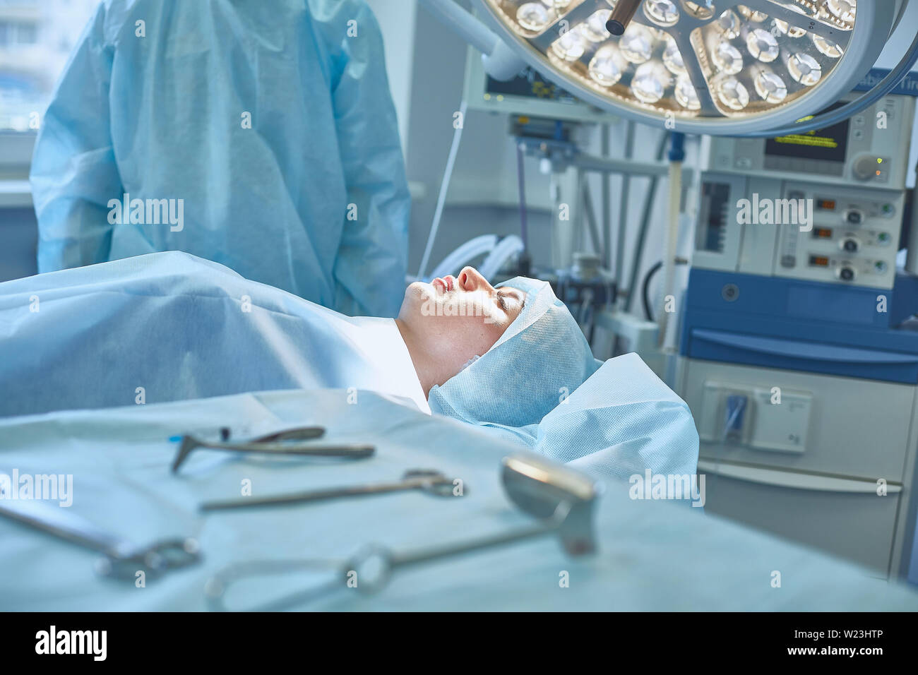 Several doctors surrounding patient on operation table during their ...