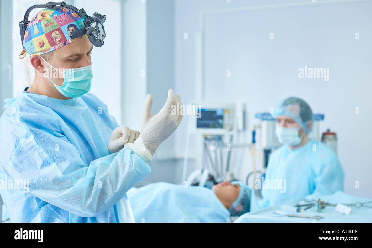 Several doctors surrounding patient on operation table during their ...
