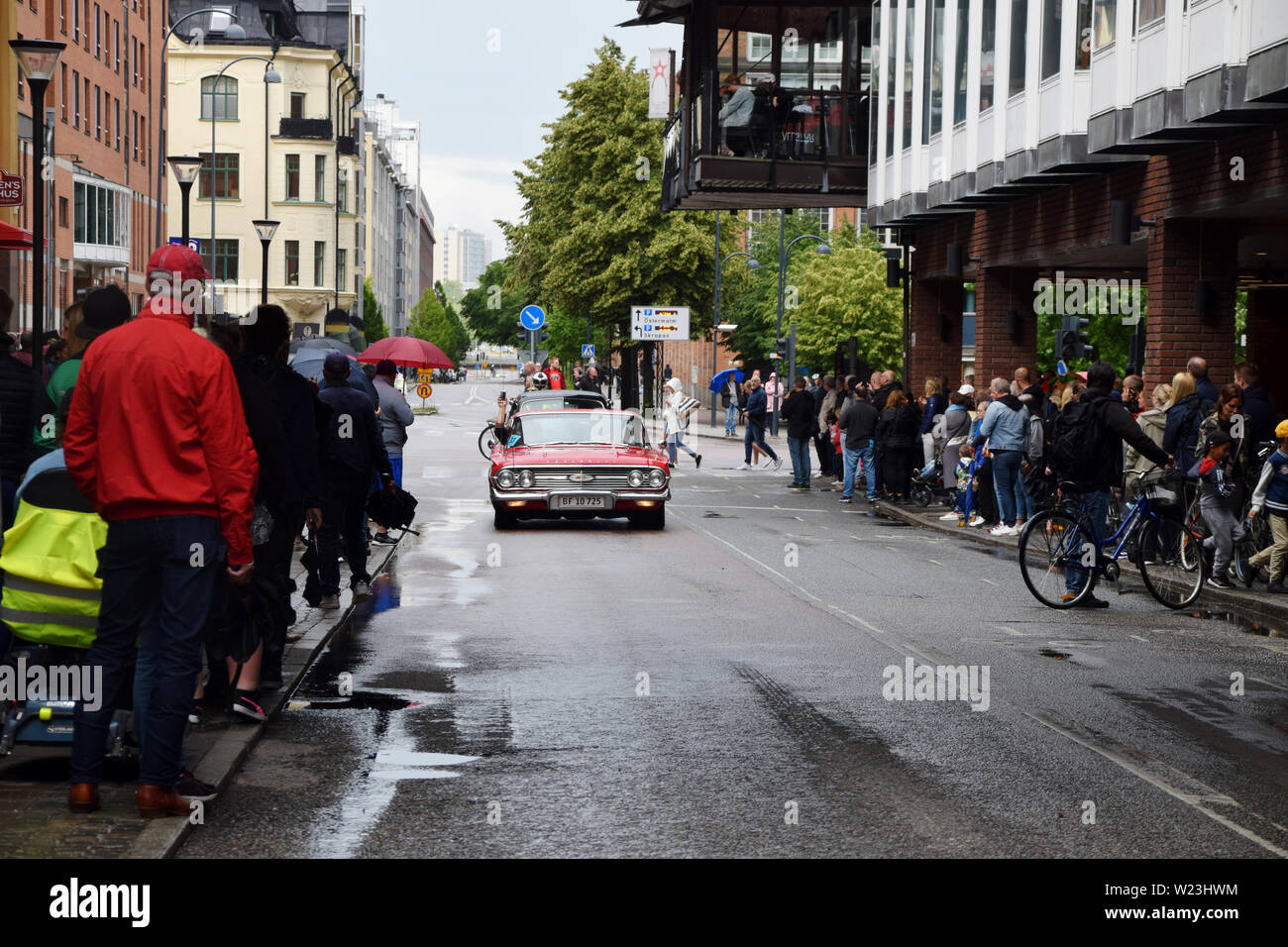 People watching American cars cruising in Västerås city during Summer ...