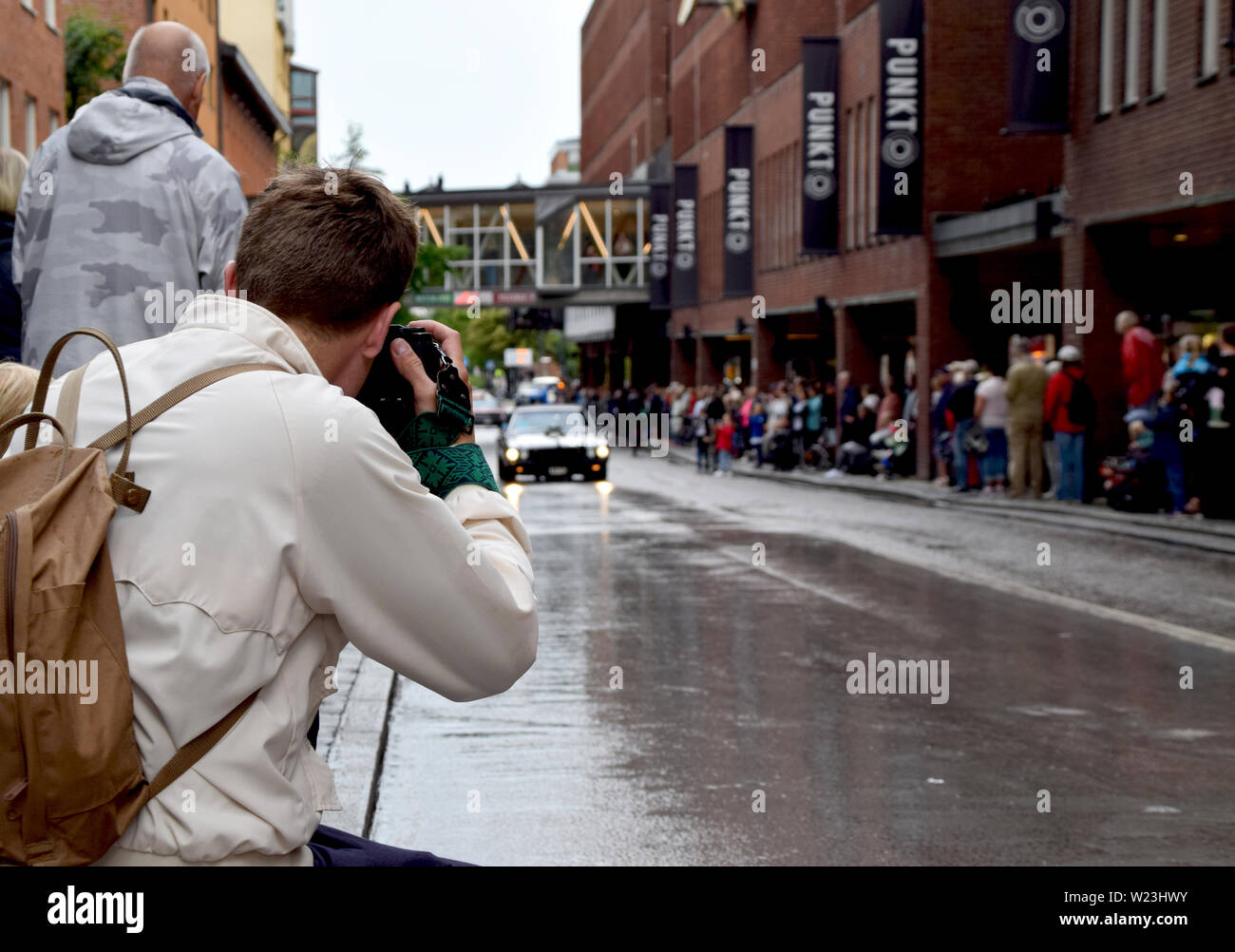 Man Taking Photos With Camera Of American Cars Cruising In V ster s Man Taking Photos With Camera Of American Cars Cruising In V ster s