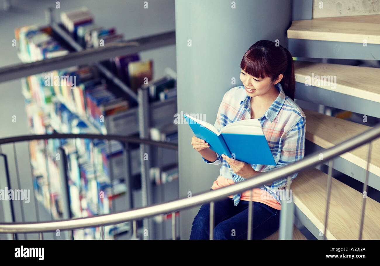 high school student girl reading book at library Stock Photo - Alamy