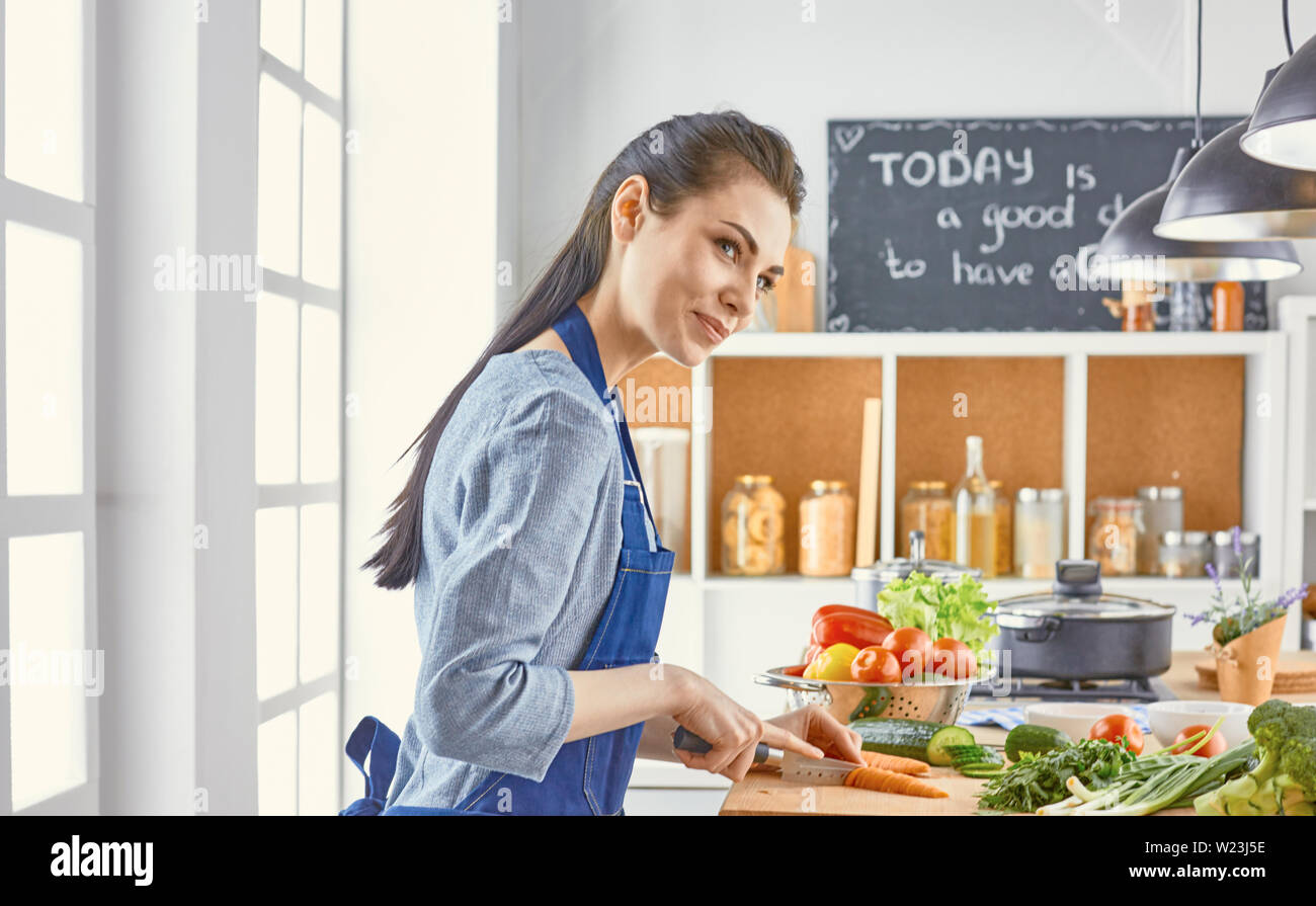 Happy woman looking recipe tablet kitchen reading cooking Stock Photo ...