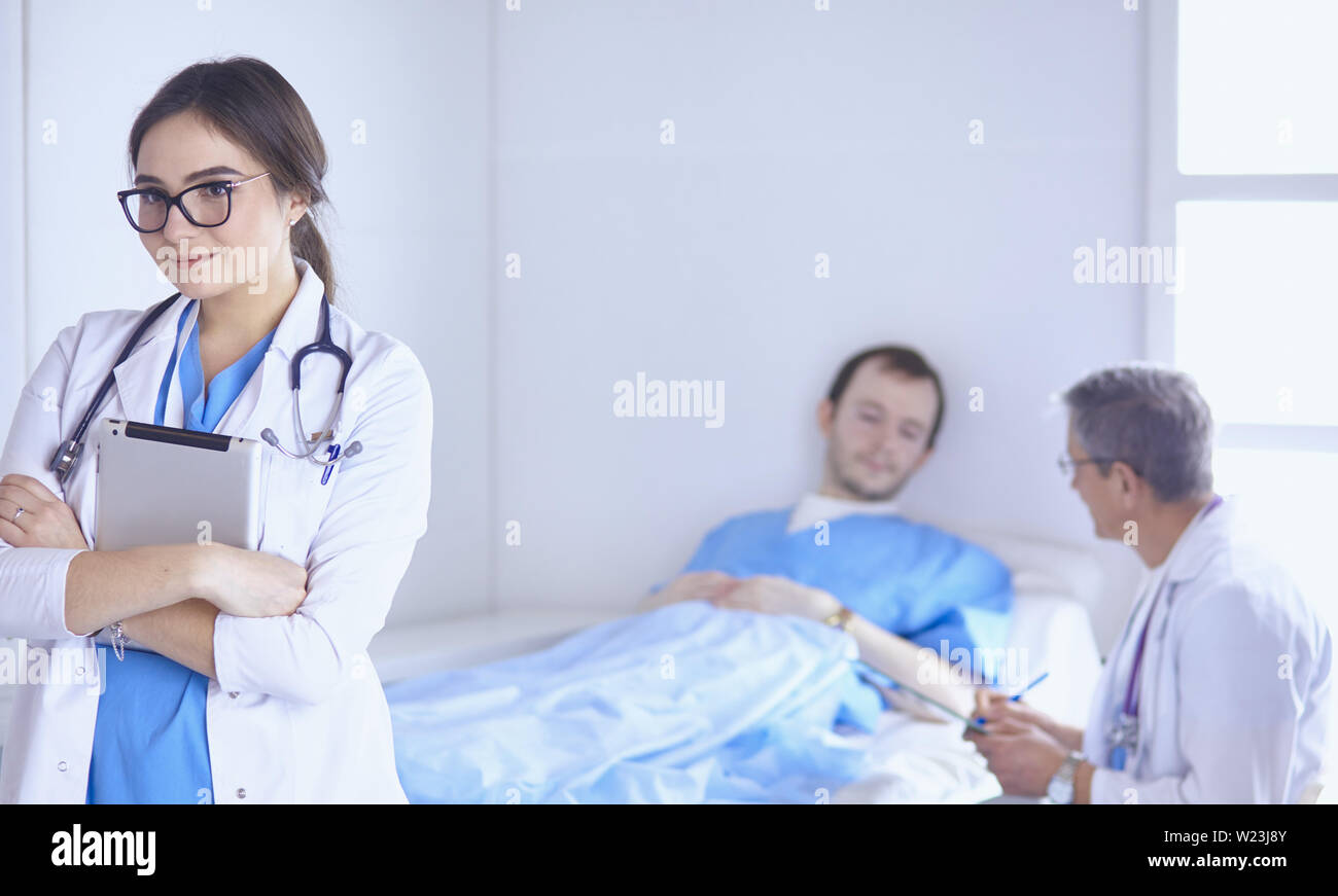 Doctor checking heart beat of patient in bed with stethoscope Stock ...