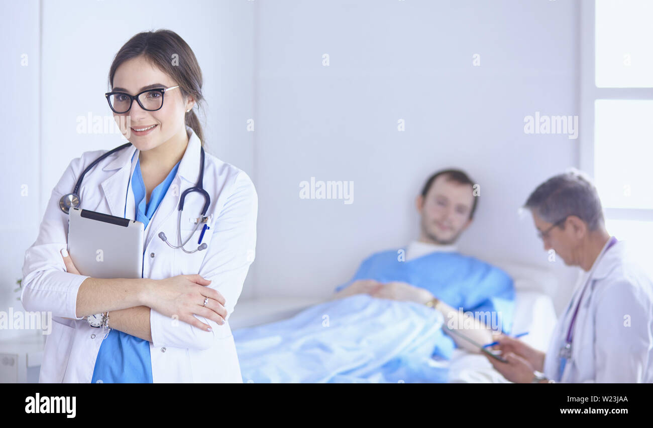 Doctor checking heart beat of patient in bed with stethoscope Stock ...