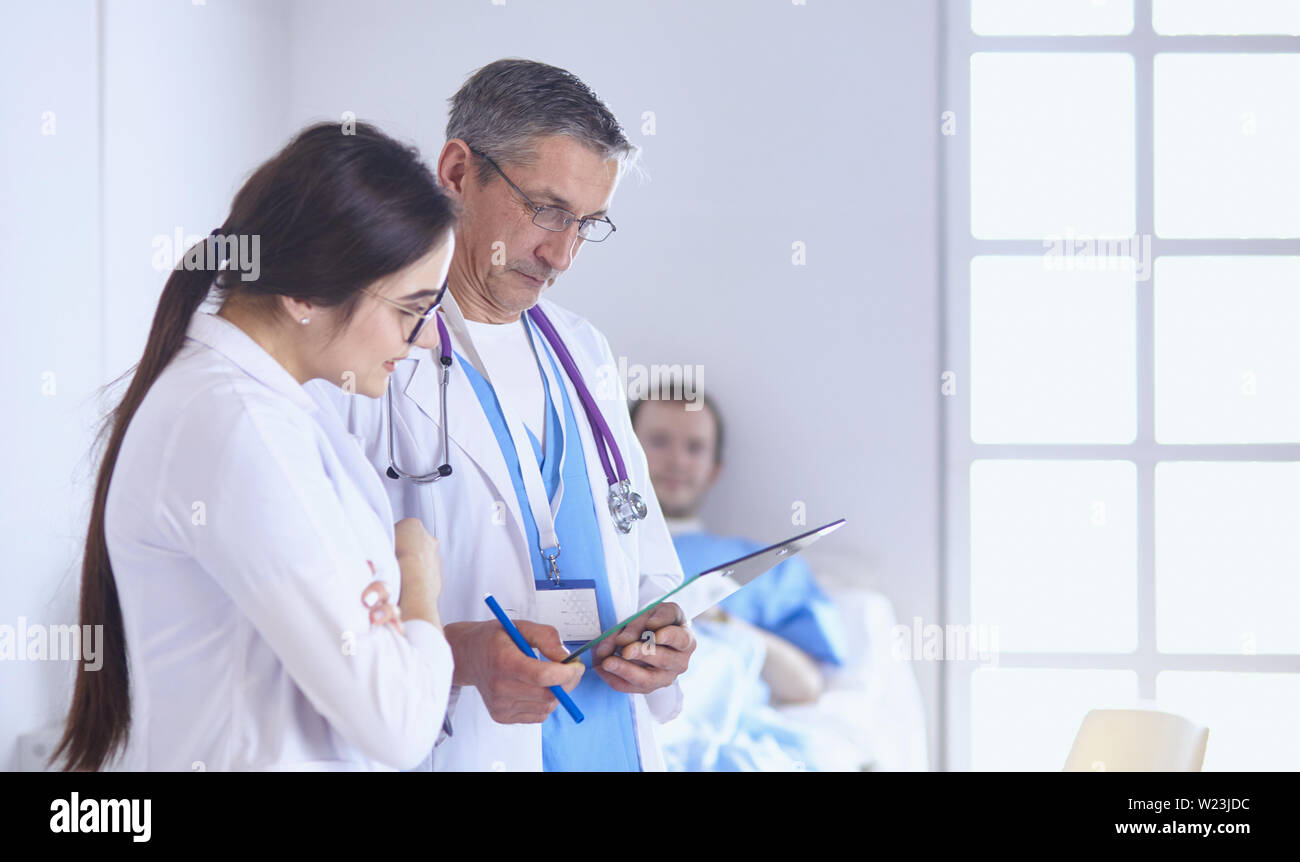 Doctor checking heart beat of patient in bed with stethoscope Stock ...