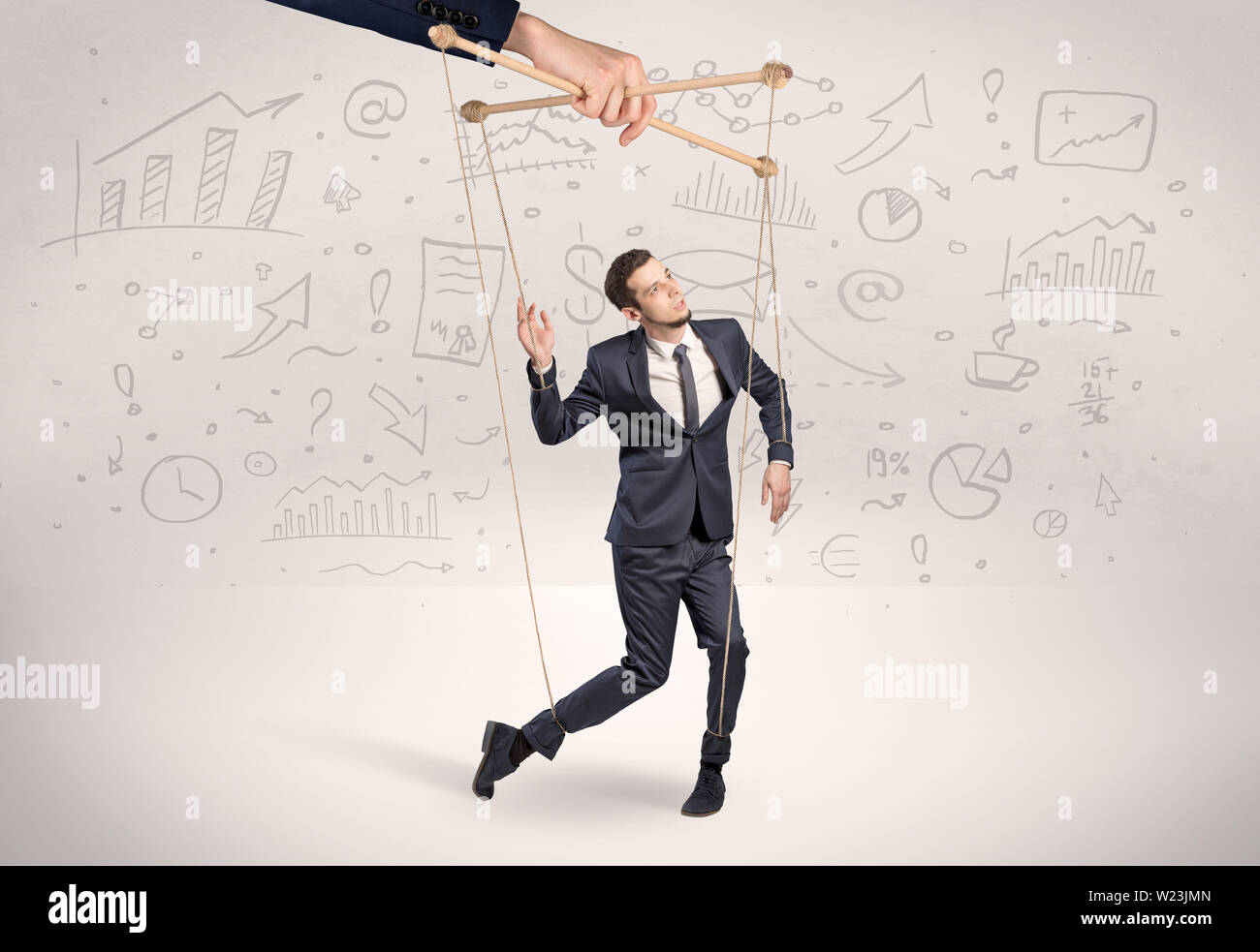 Puppet employee controlled by a big hand with documents and staffs ...