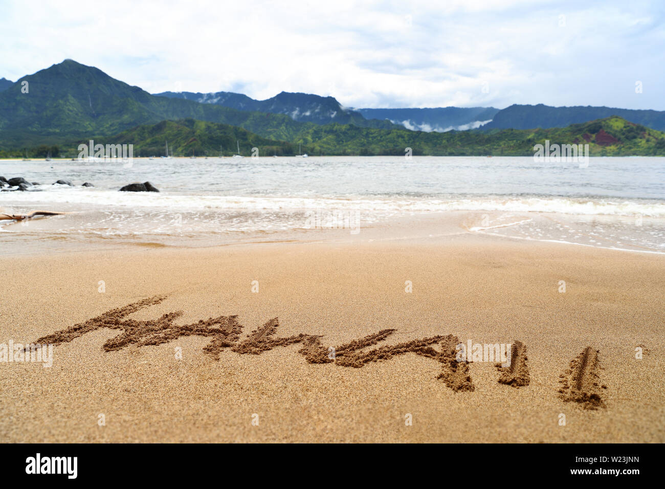 Hawaii word written on sand on hawaiian beach. Handwriting text texture ...