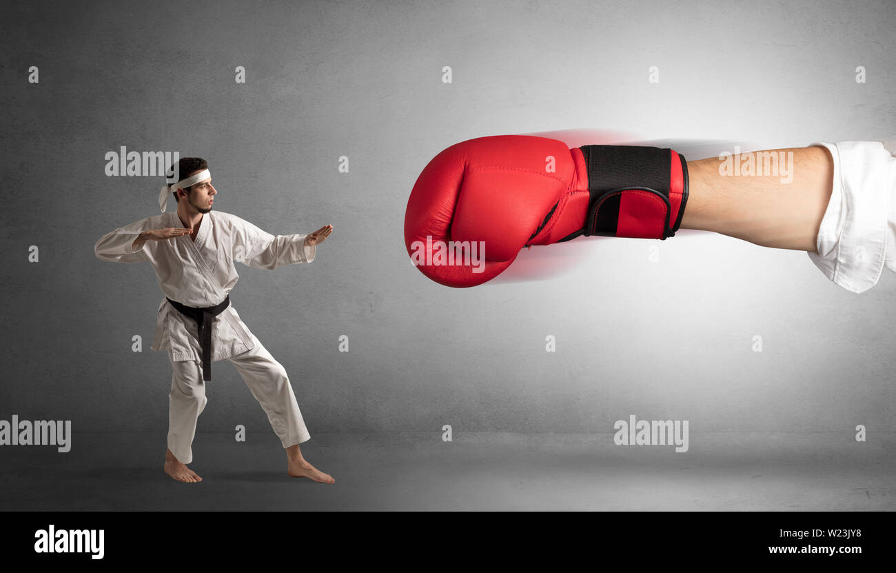 Little man fighting with a giant red boxing glove Stock Photo - Alamy