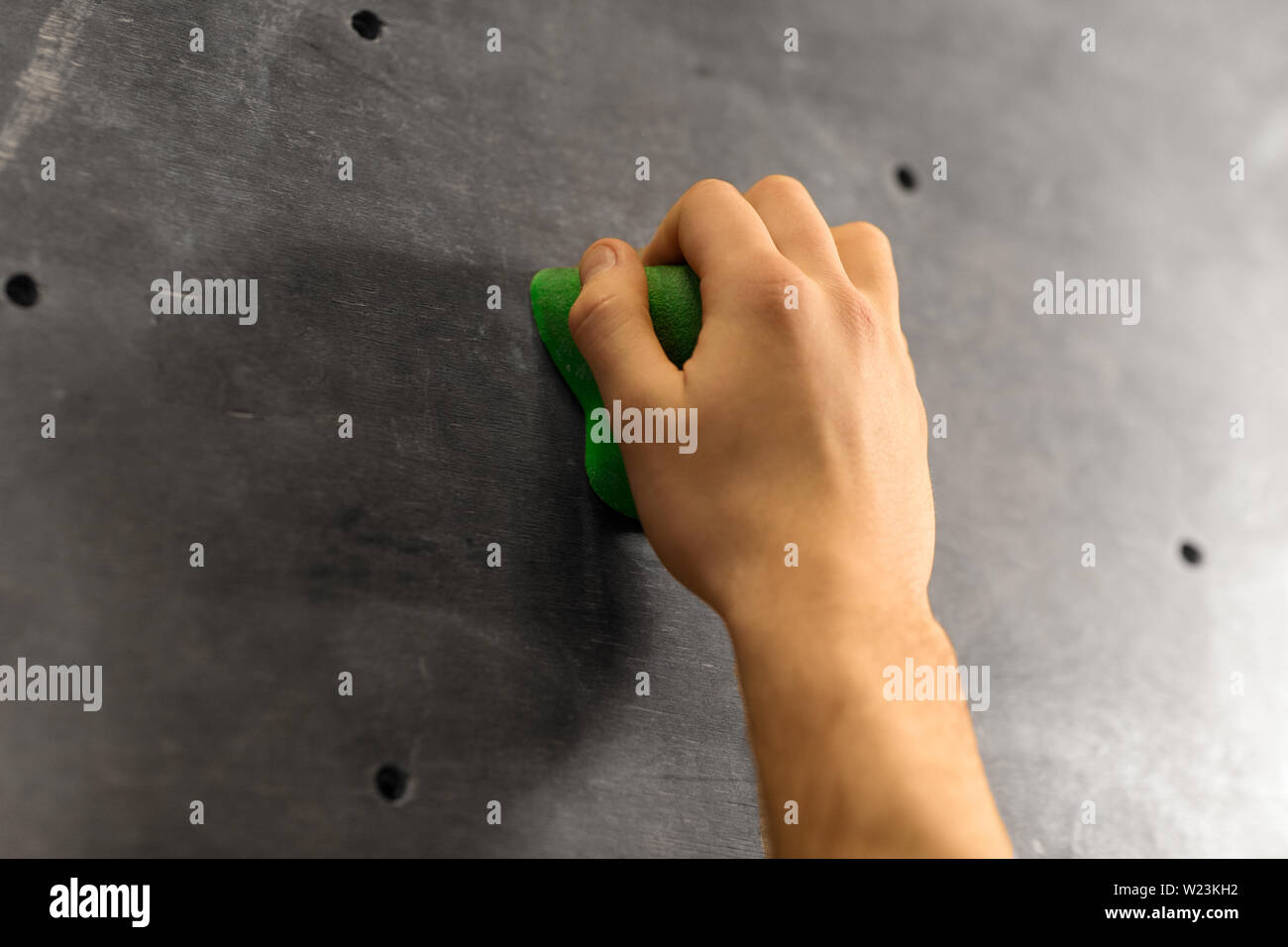 male hand holding to indoor climbing wall Stock Photo - Alamy