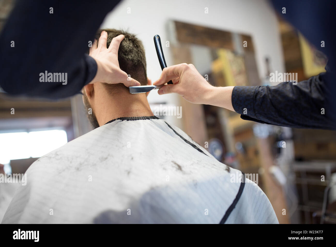 man and barber with straight razor shaving hair Stock Photo - Alamy