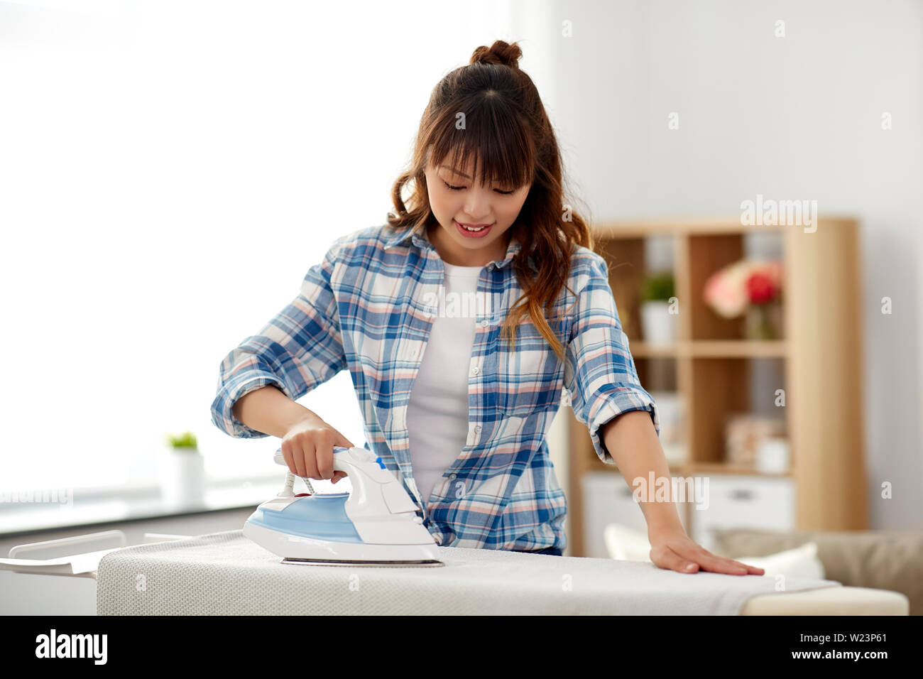 Woman ironing at home hi-res stock photography and images - Alamy