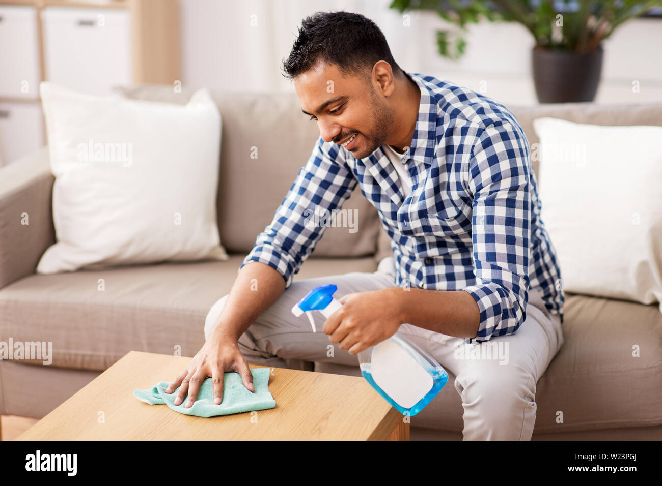 indian man cleaning table with detergent at home Stock Photo - Alamy