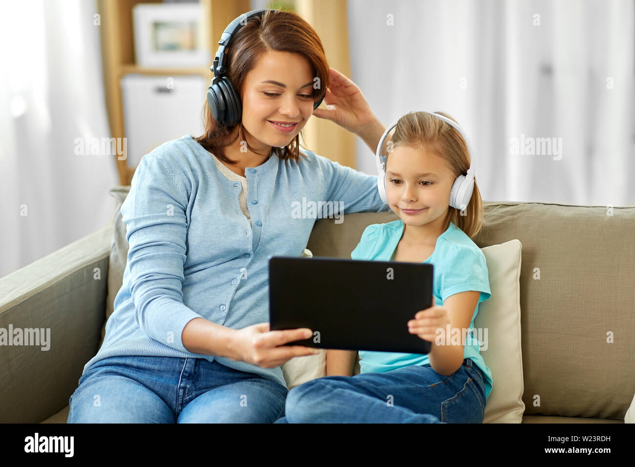 mother and daughter listen to music on tablet pc Stock Photo - Alamy