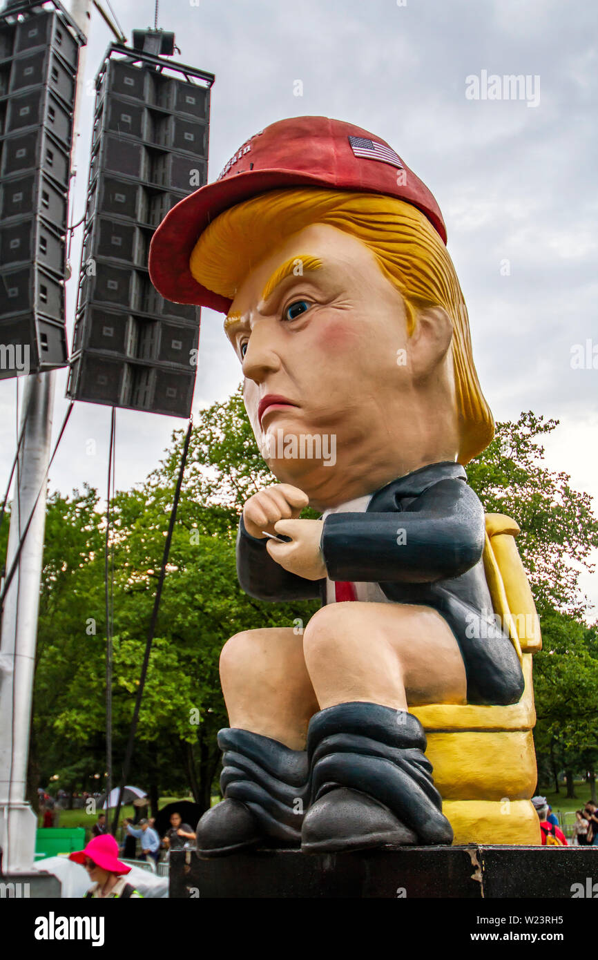 An effigy of Donald Trump looms over the crowd amid protests on ...