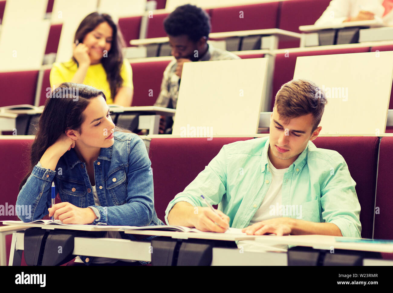 group of students with notebooks in lecture hall Stock Photo - Alamy