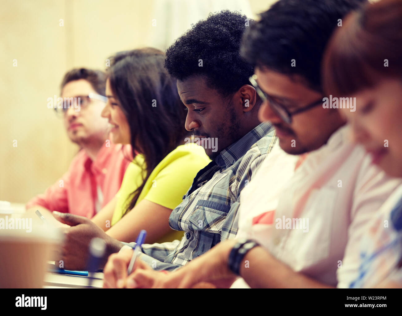 group of international students writing at lecture Stock Photo - Alamy