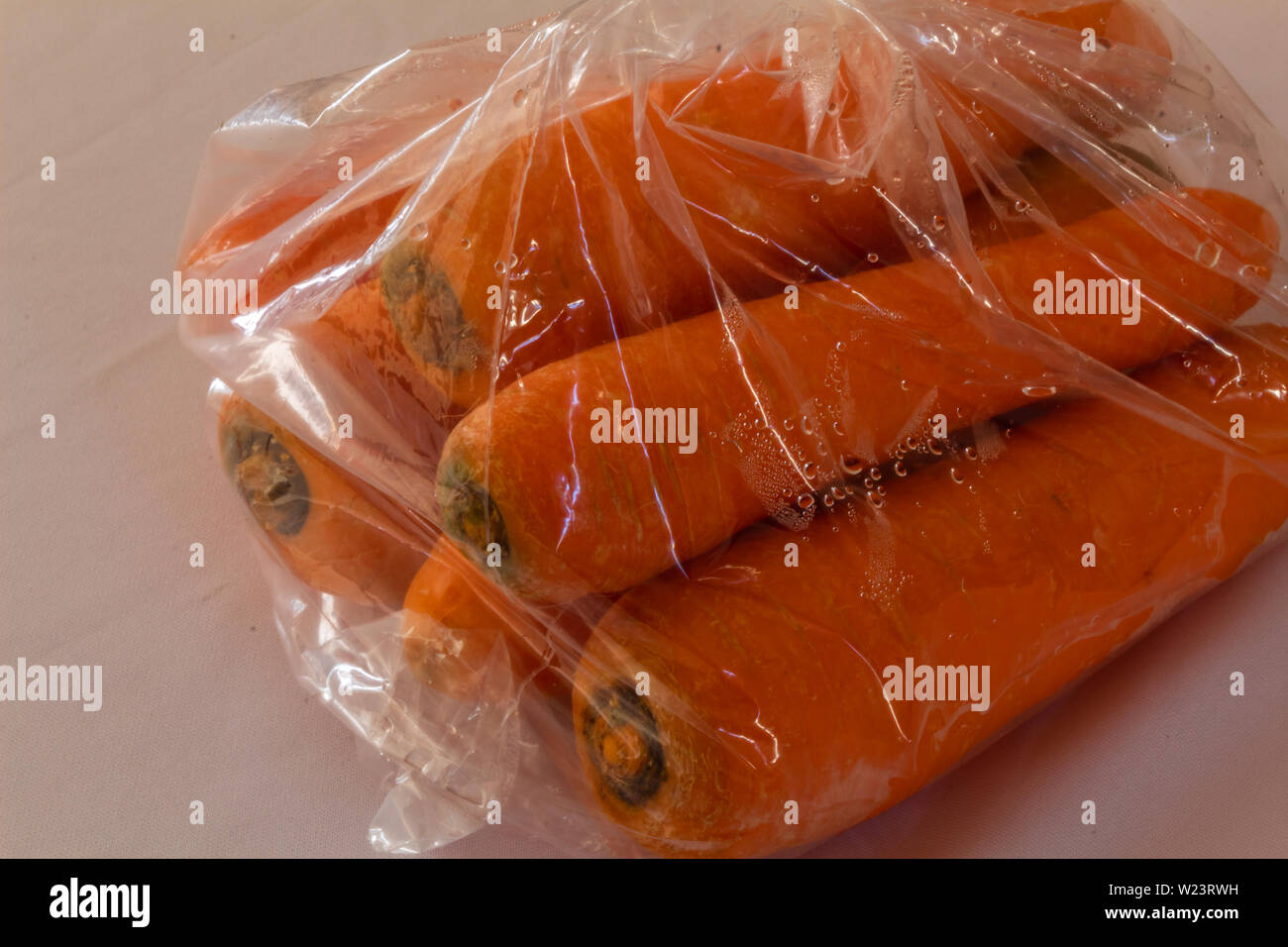 Many carrots inside a bag, with a white background Stock Photo - Alamy