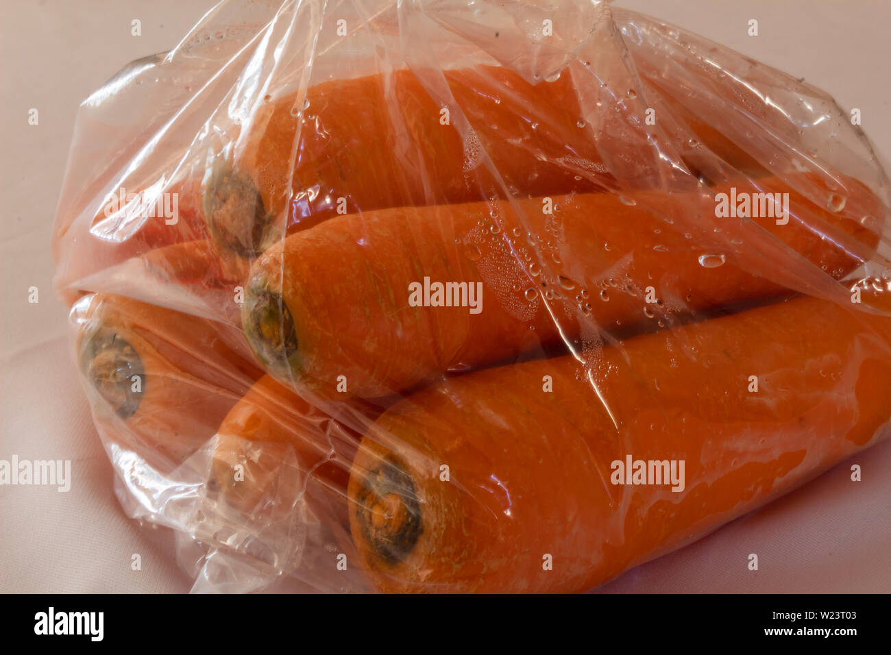 Many carrots inside a bag, with a white background Stock Photo - Alamy