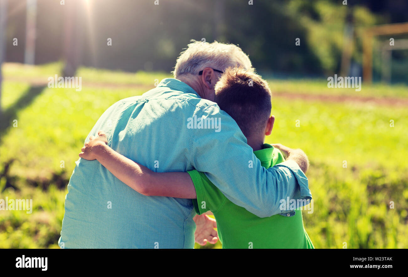 grandfather and grandson hugging outdoors Stock Photo - Alamy