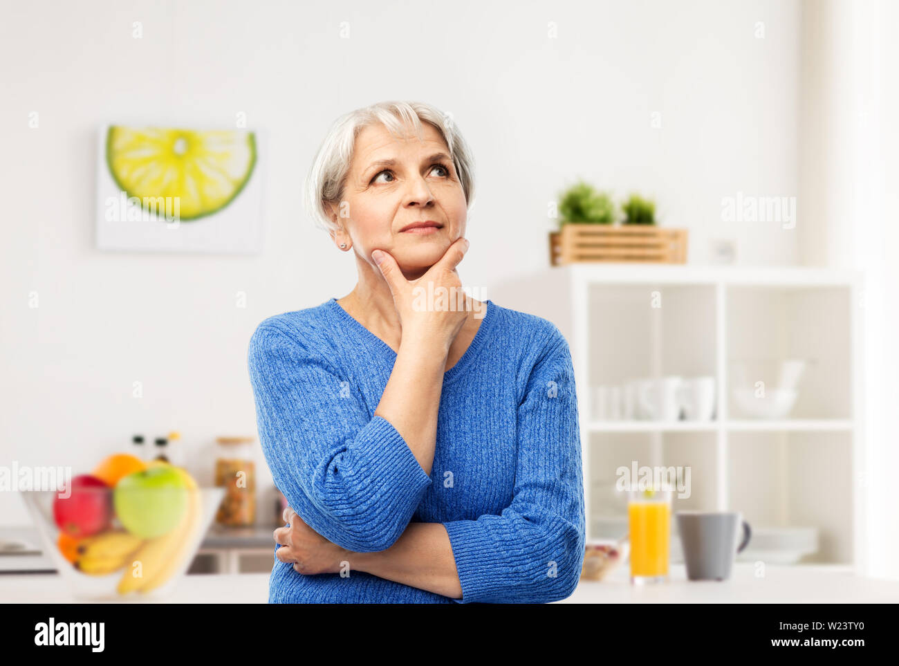 portrait of senior woman thinking in kitchen Stock Photo - Alamy