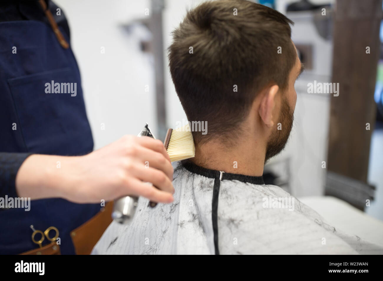 male client and barber cleaning hair from neck Stock Photo - Alamy