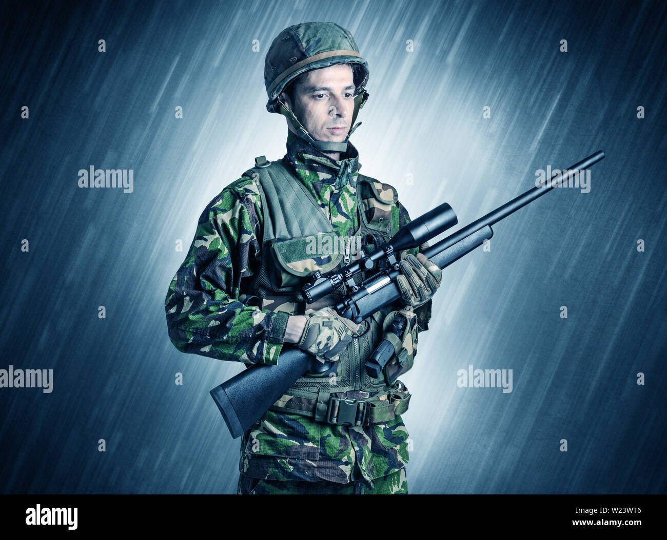 Armed soldier standing in rainy weather Stock Photo - Alamy
