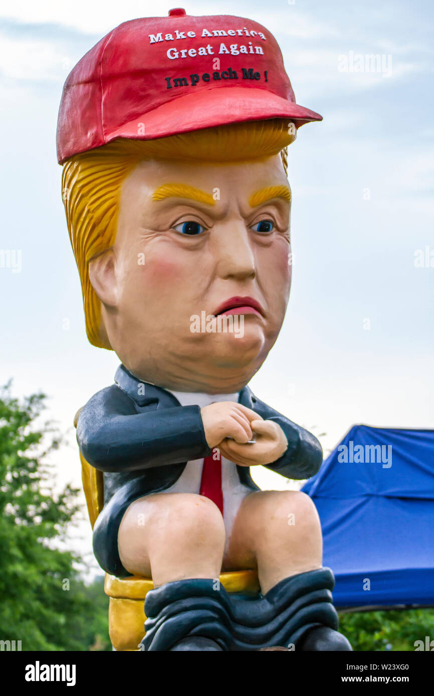 An effigy of Donald Trump looms over the crowd amid protests on ...