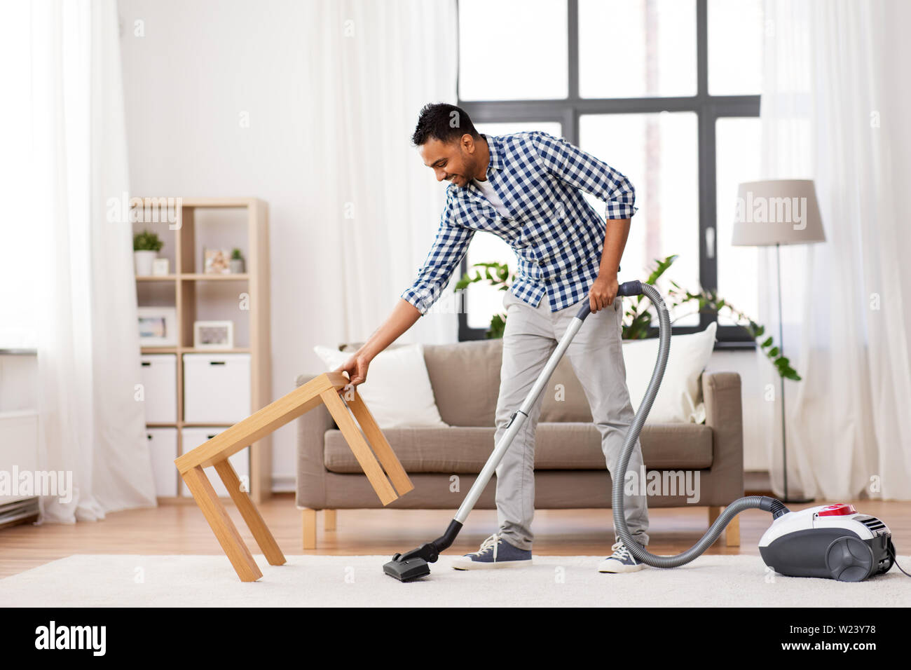 indian man with vacuum cleaner at home Stock Photo - Alamy