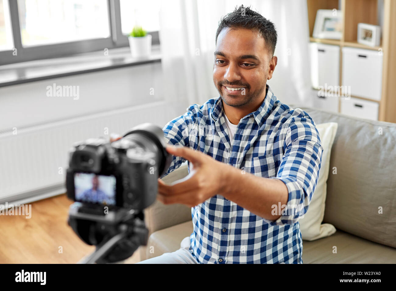 indian male video blogger adjusting camera at home Stock Photo - Alamy
