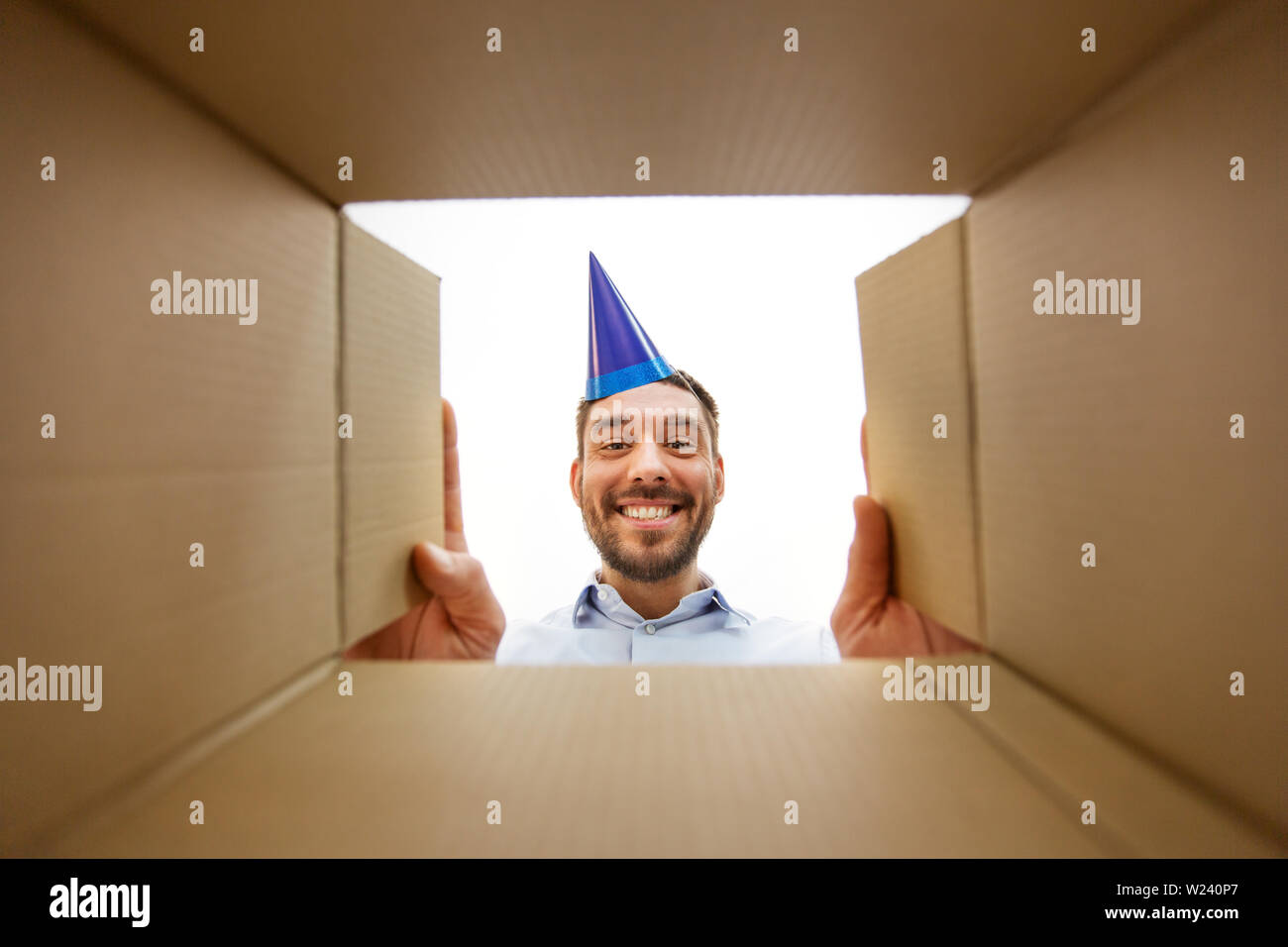 happy man opening parcel box or birthday gift Stock Photo - Alamy