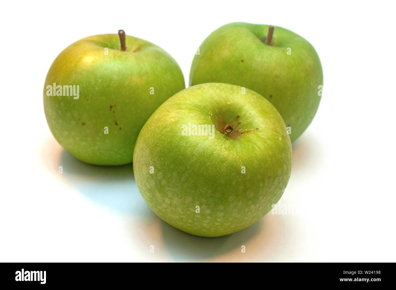Green ripe granny apples on a white background Stock Photo - Alamy