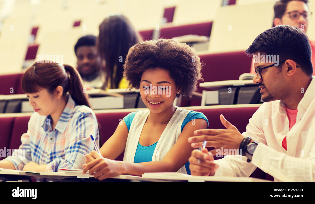 group of students with notebooks in lecture hall Stock Photo - Alamy