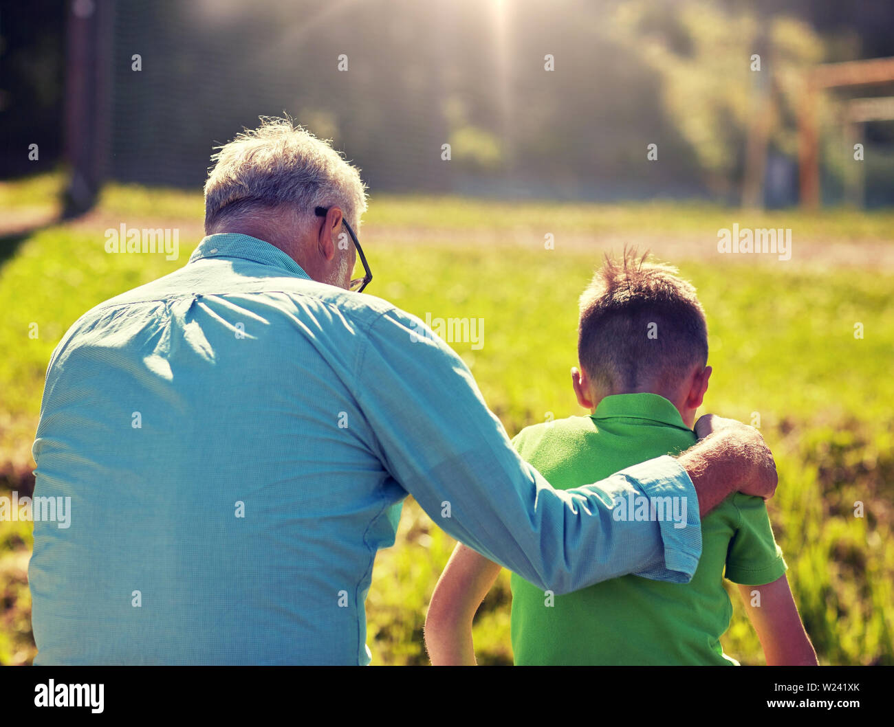 grandfather and grandson hugging outdoors Stock Photo - Alamy