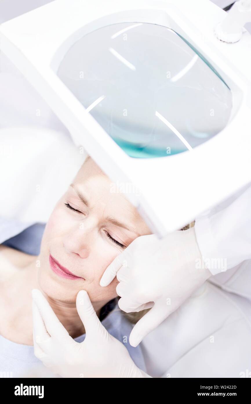 Dermatological examination dermatologist using magnifying hi-res stock ...