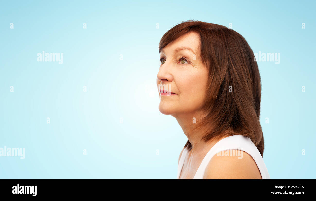 portrait of senior woman over blue background Stock Photo - Alamy