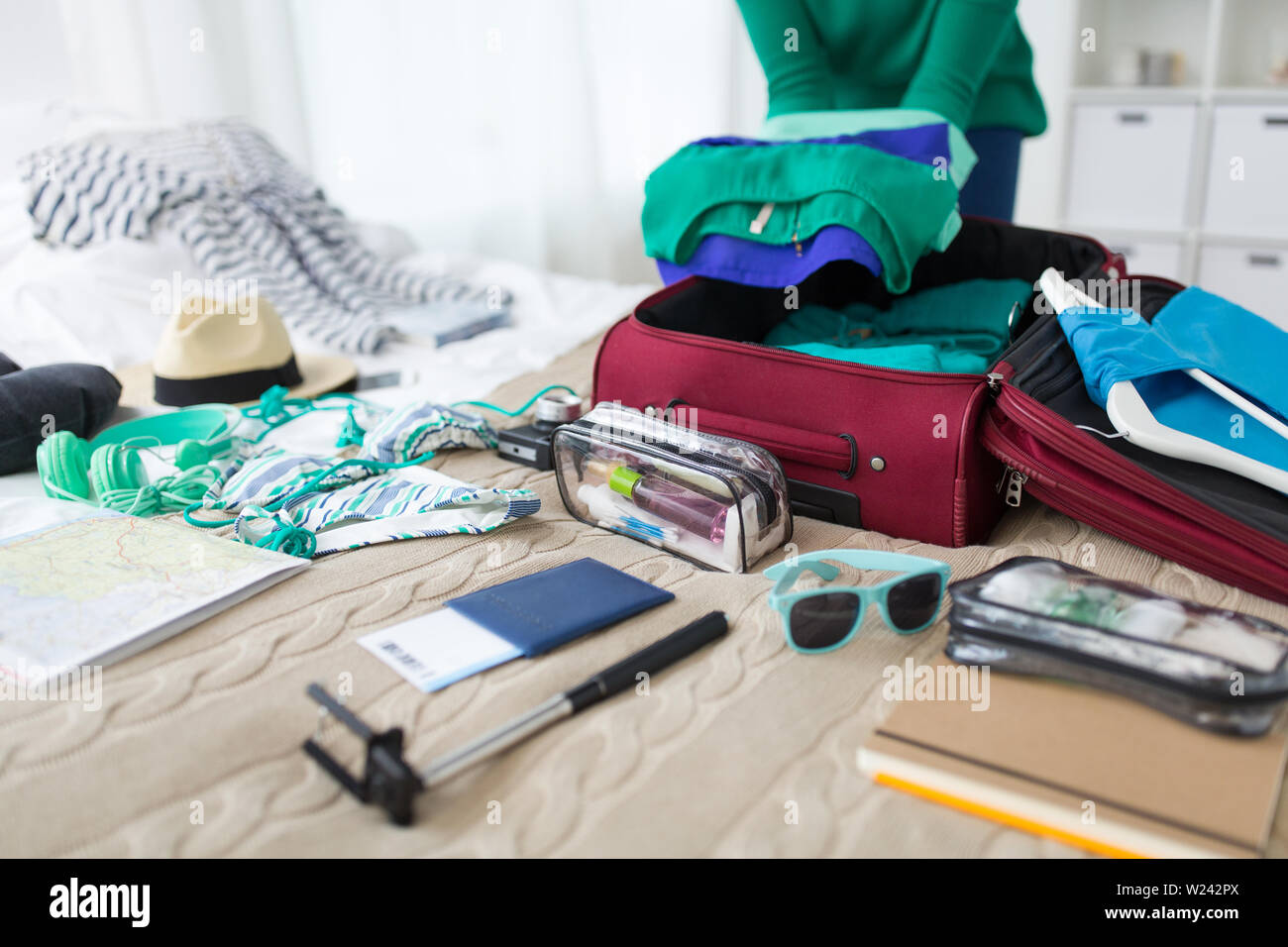 woman packing travel bag at home or hotel room Stock Photo - Alamy