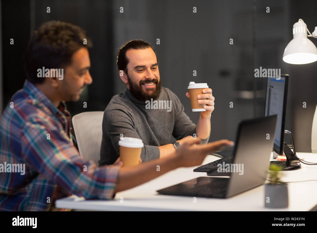 creative team drinking coffee at night office Stock Photo - Alamy