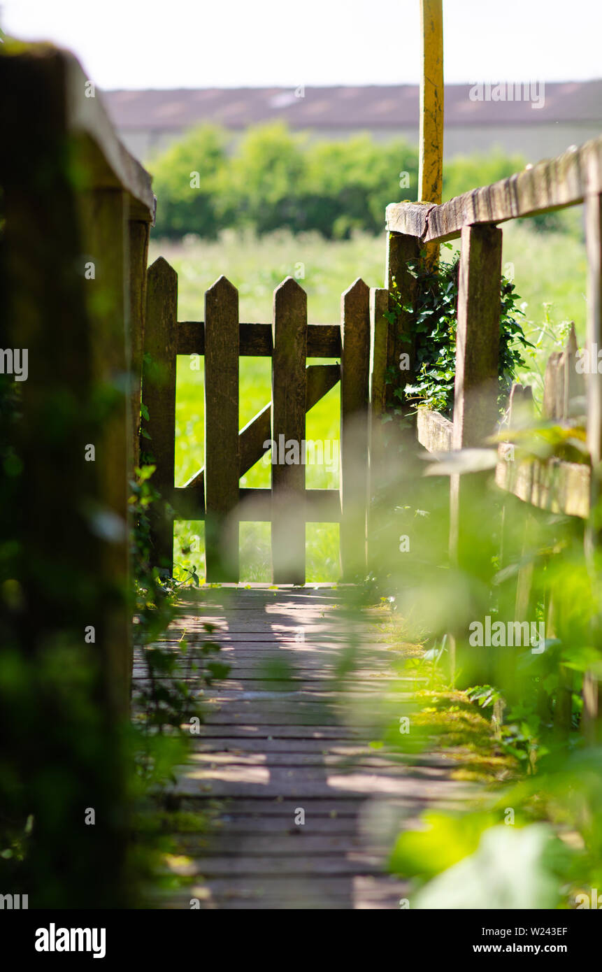 Footpath with a wooden gates at little English town. Stone ...