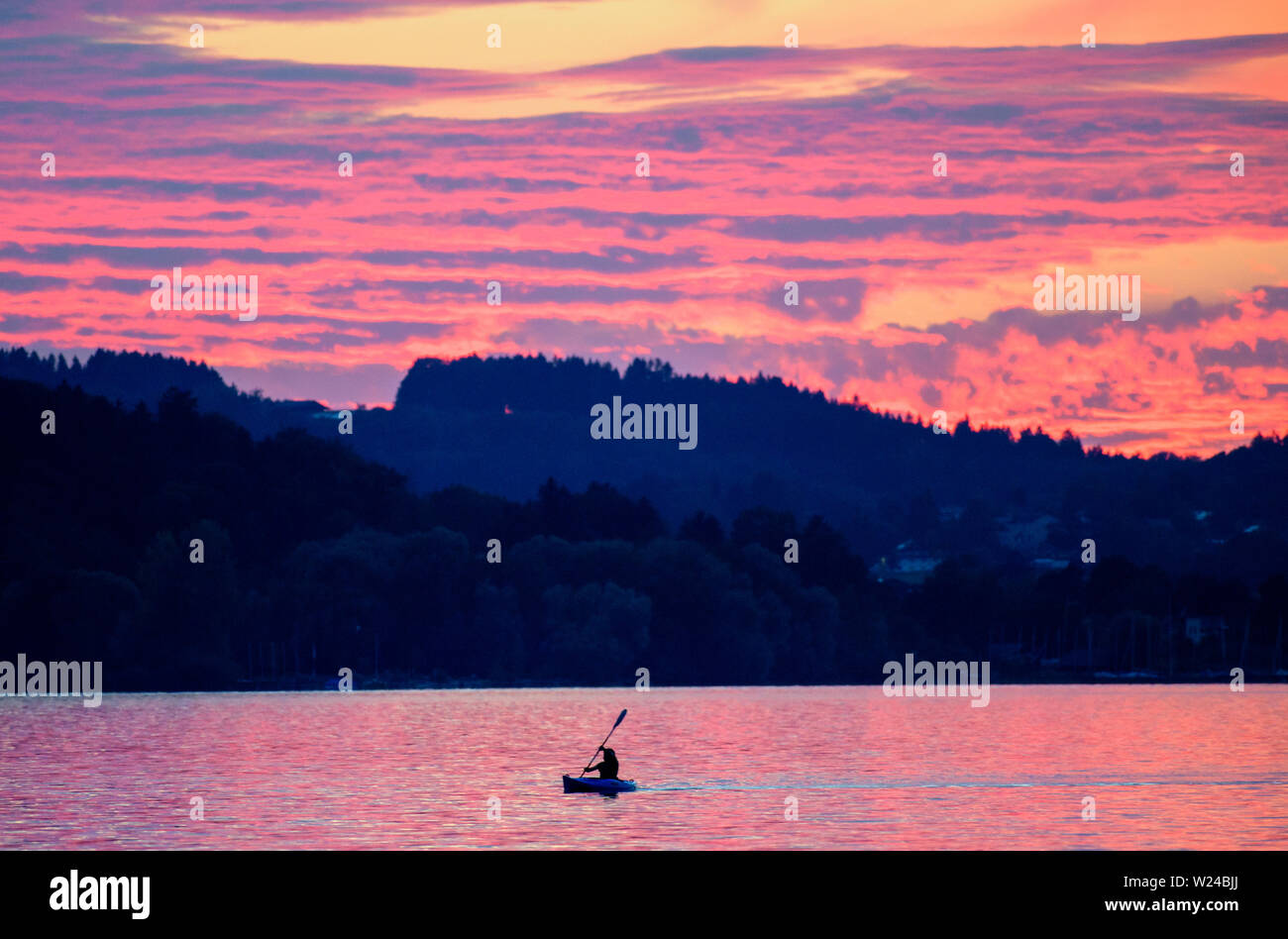 Bernau, Germany. 05th July, 2019. A kayaker paddles over Lake Chiemsee ...