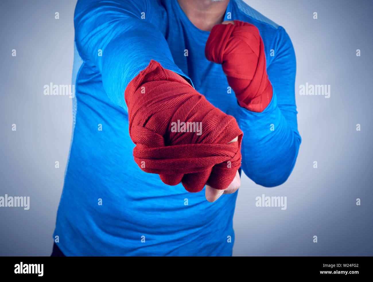 athlete in a blue dress standing in a combat sport aggressive stance ...