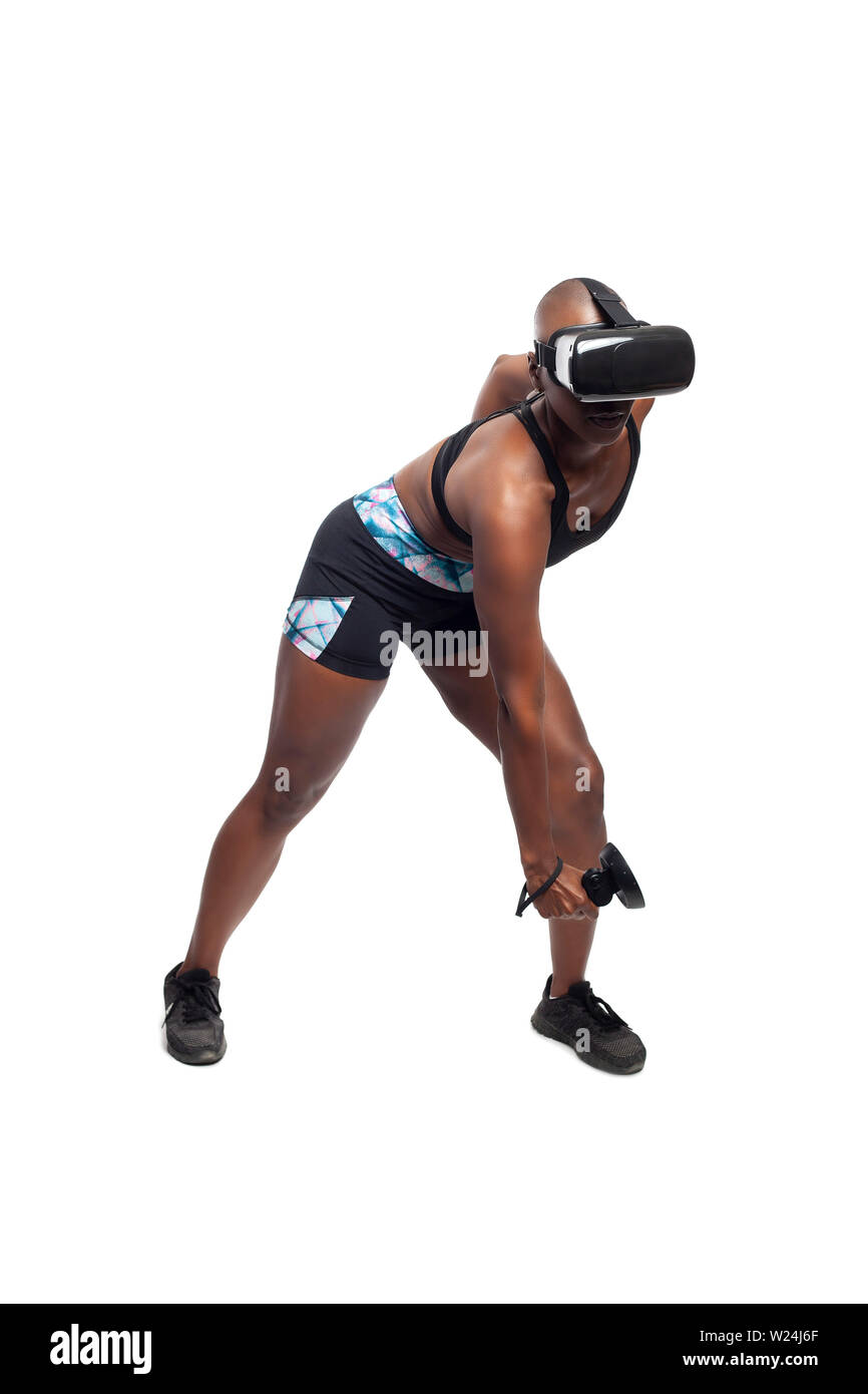 Athletic black female gamer wearing a vr headset and exercising in a ...