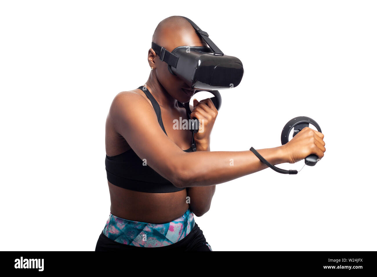Athletic black female gamer playing video games and exercising while ...