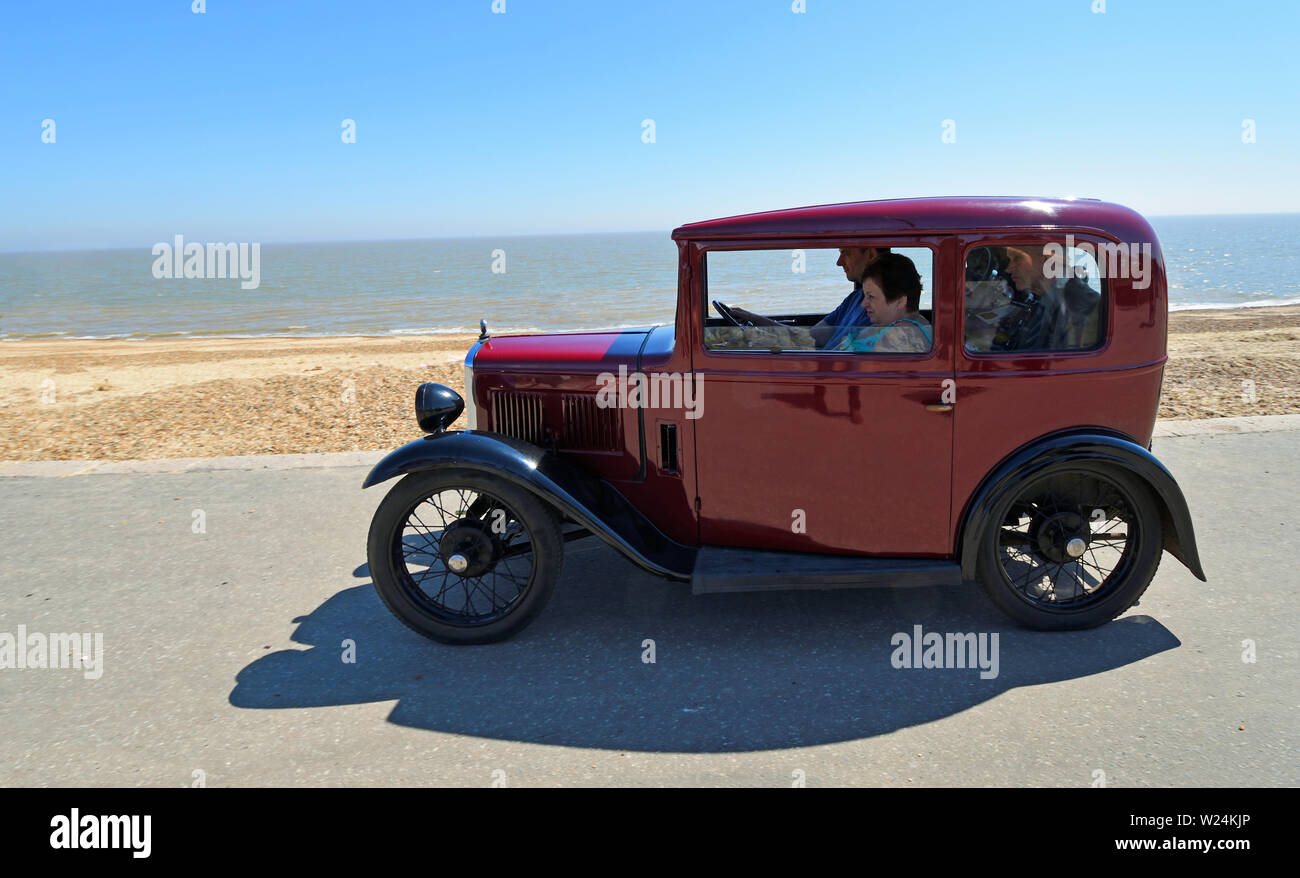 Classic Red Austin Seven Car being driven along Seafront Promenade ...