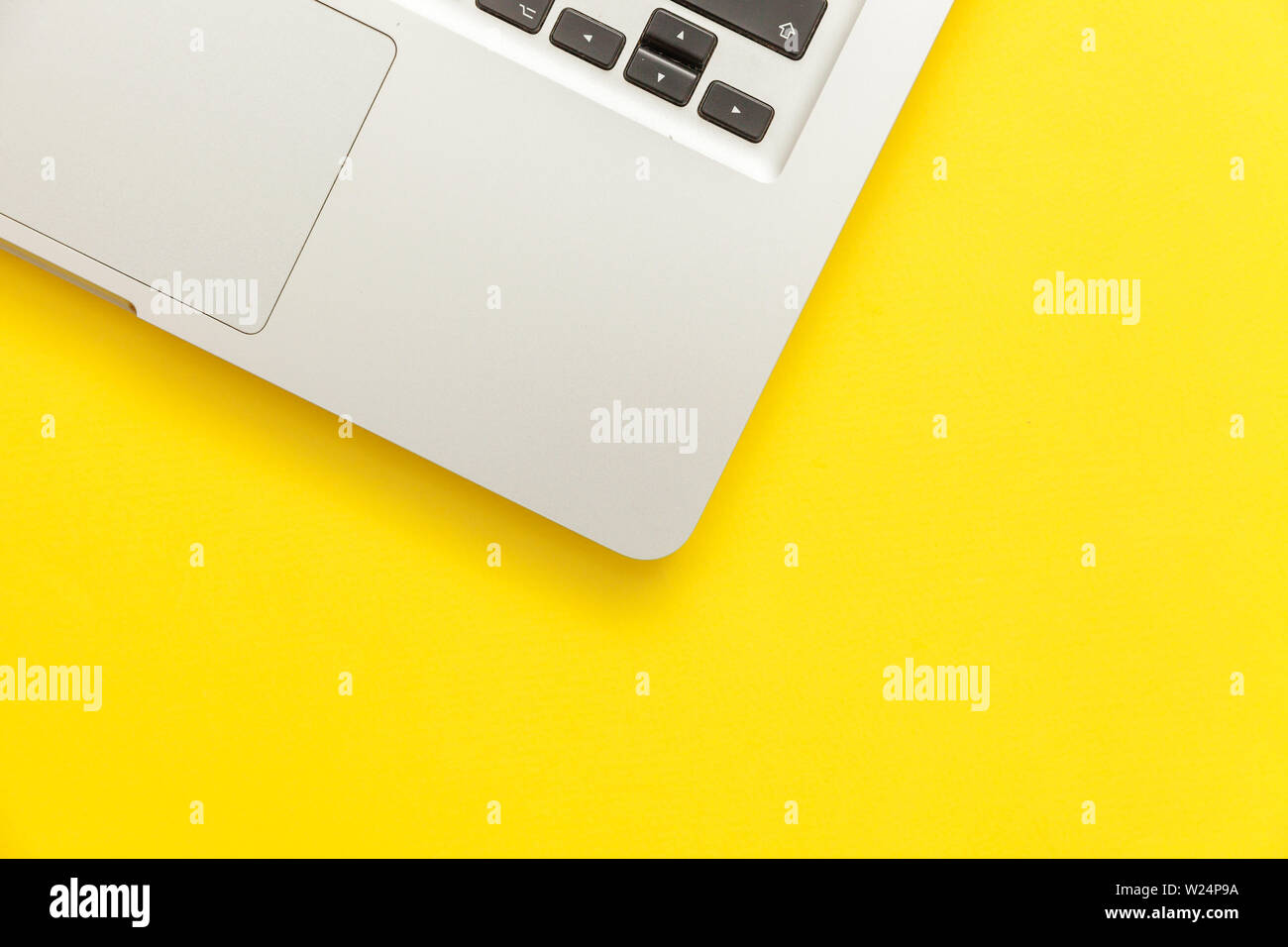 Keyboard laptop computer isolated on yellow desk background. Modern ...