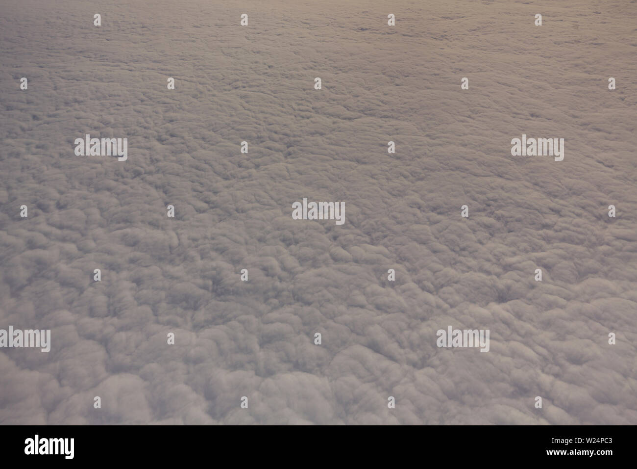 Layer of clouds taken from aircraft above scene illuminated by low ...