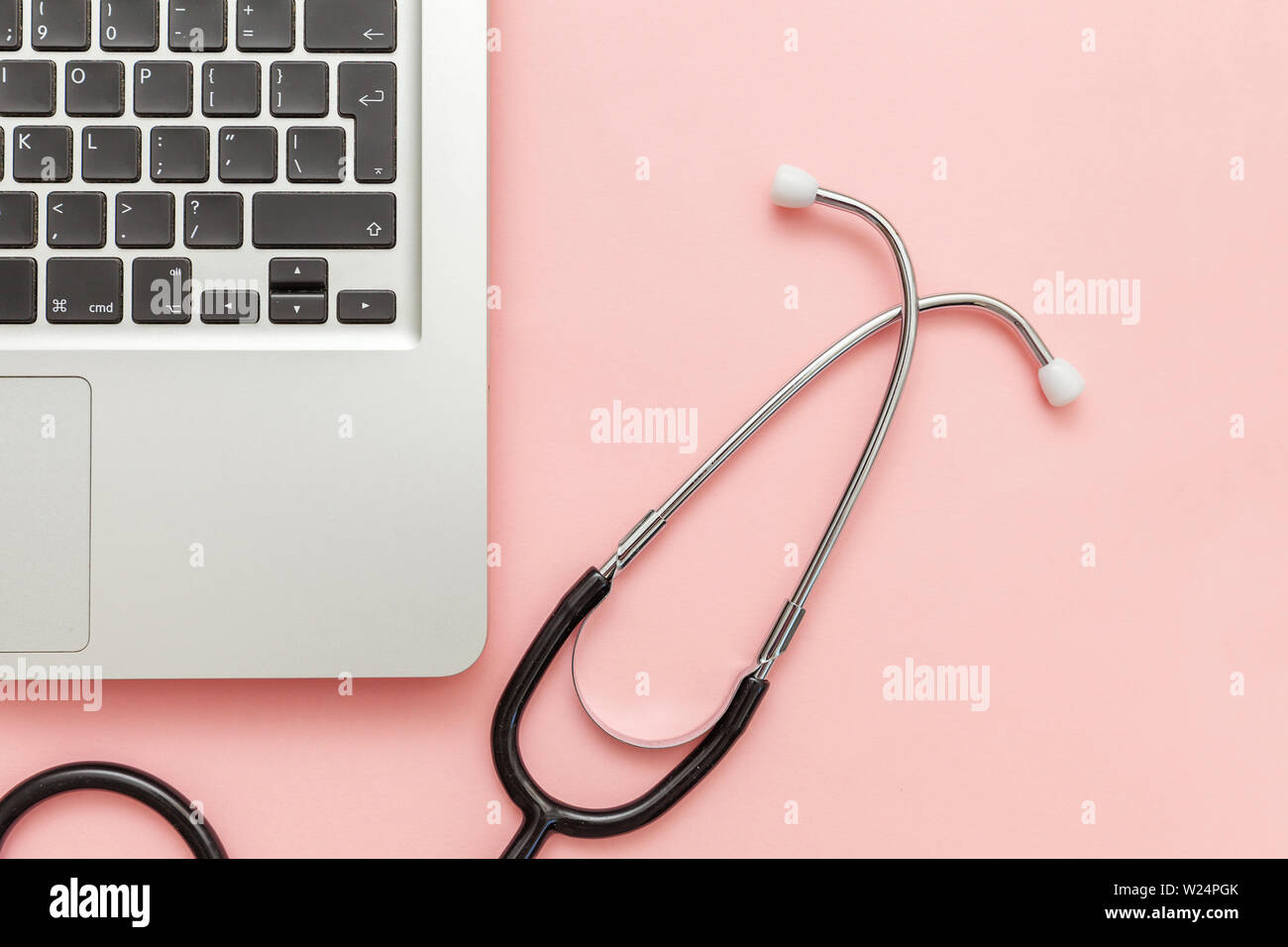 Stethoscope keyboard laptop computer isolated on pink background ...