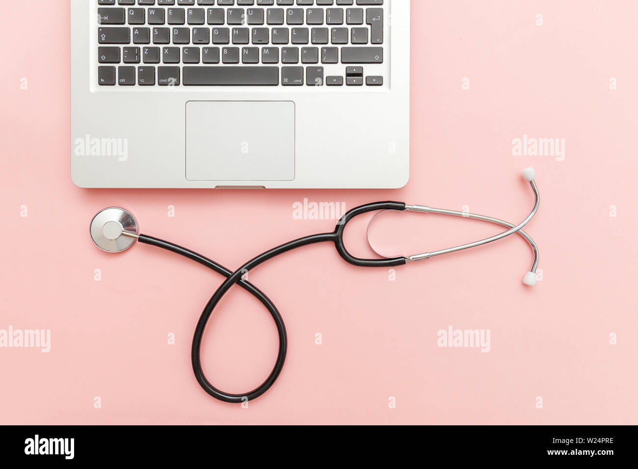 Stethoscope keyboard laptop computer isolated on pink background ...
