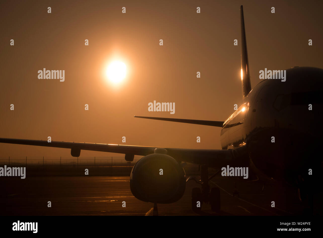 Large passenger aircraft shining in evening light waiting for flight on ...