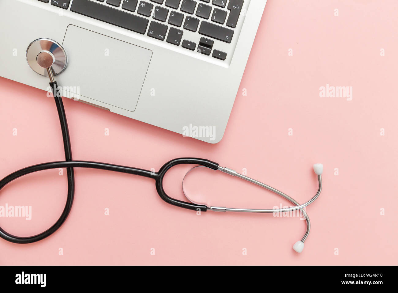 Stethoscope keyboard laptop computer isolated on pink background ...